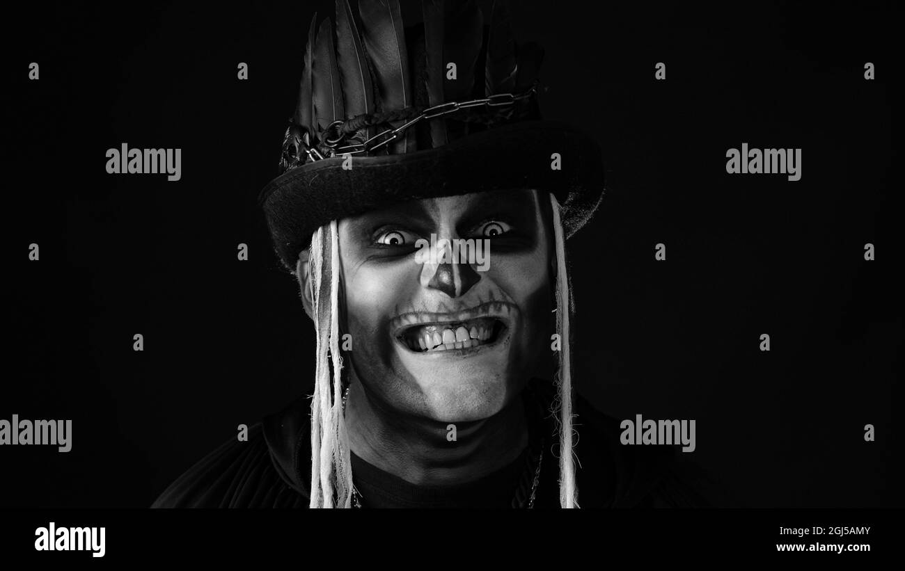 Creepy man with skeleton makeup in top-hat. Guy making faces, toothy ...