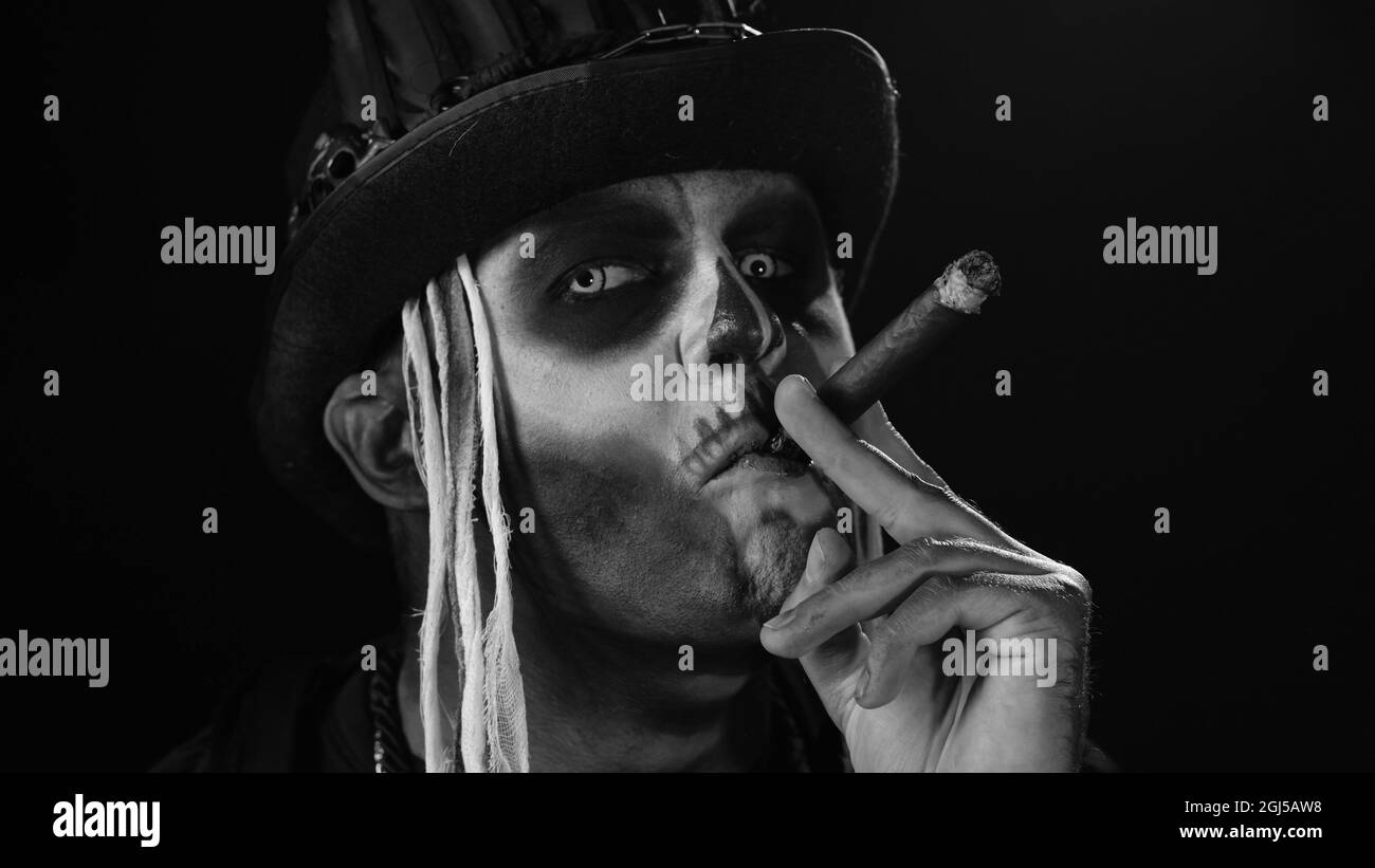 Sinister man with horrible Halloween holiday skeleton makeup raising ...