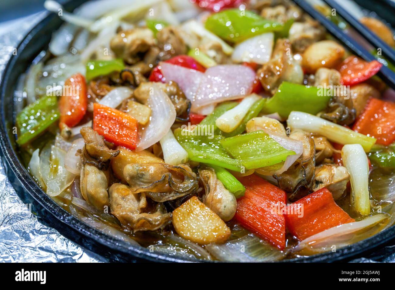 Delicious seafood dishes, sizzling buttered oysters Stock Photo - Alamy