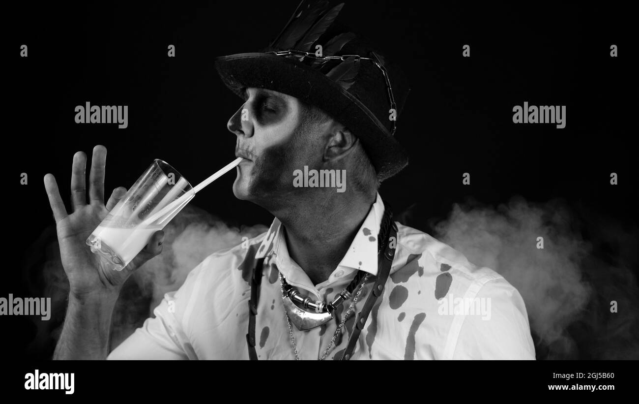 Scary guy in carnival costume of Halloween skeleton looking at camera ...