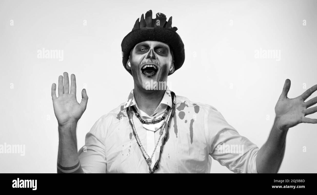 Scary guy in costume of Halloween skeleton wearing earphones, listening ...
