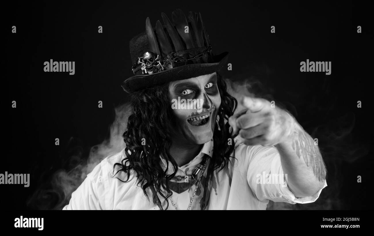 Frightening smiling man in skeleton Halloween costume in bloody shirt ...