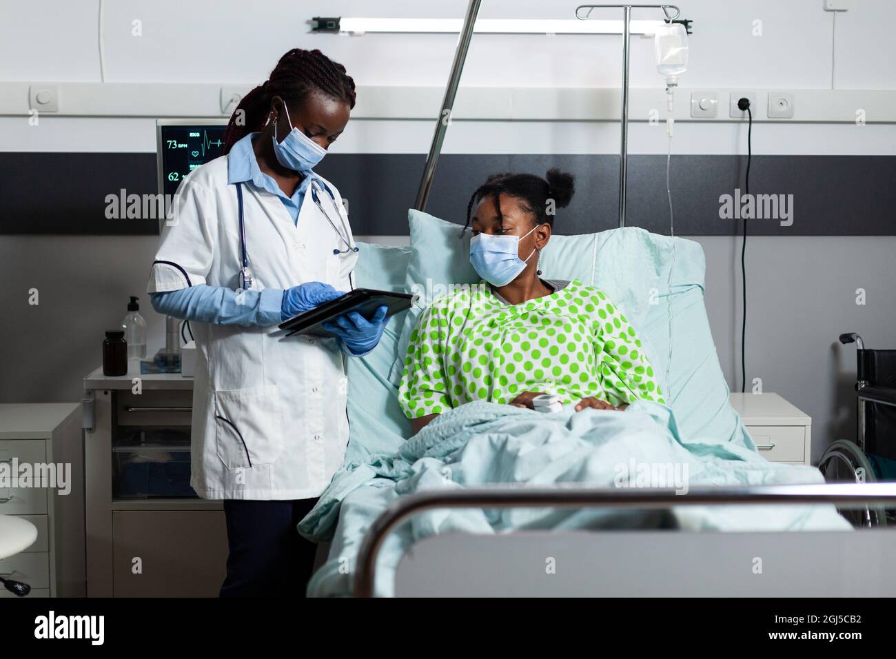 African american medic checking disease treatment on young patient with ...