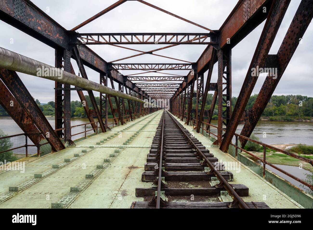 Old railway line crossing a rusty bridge turned into recreational track ...