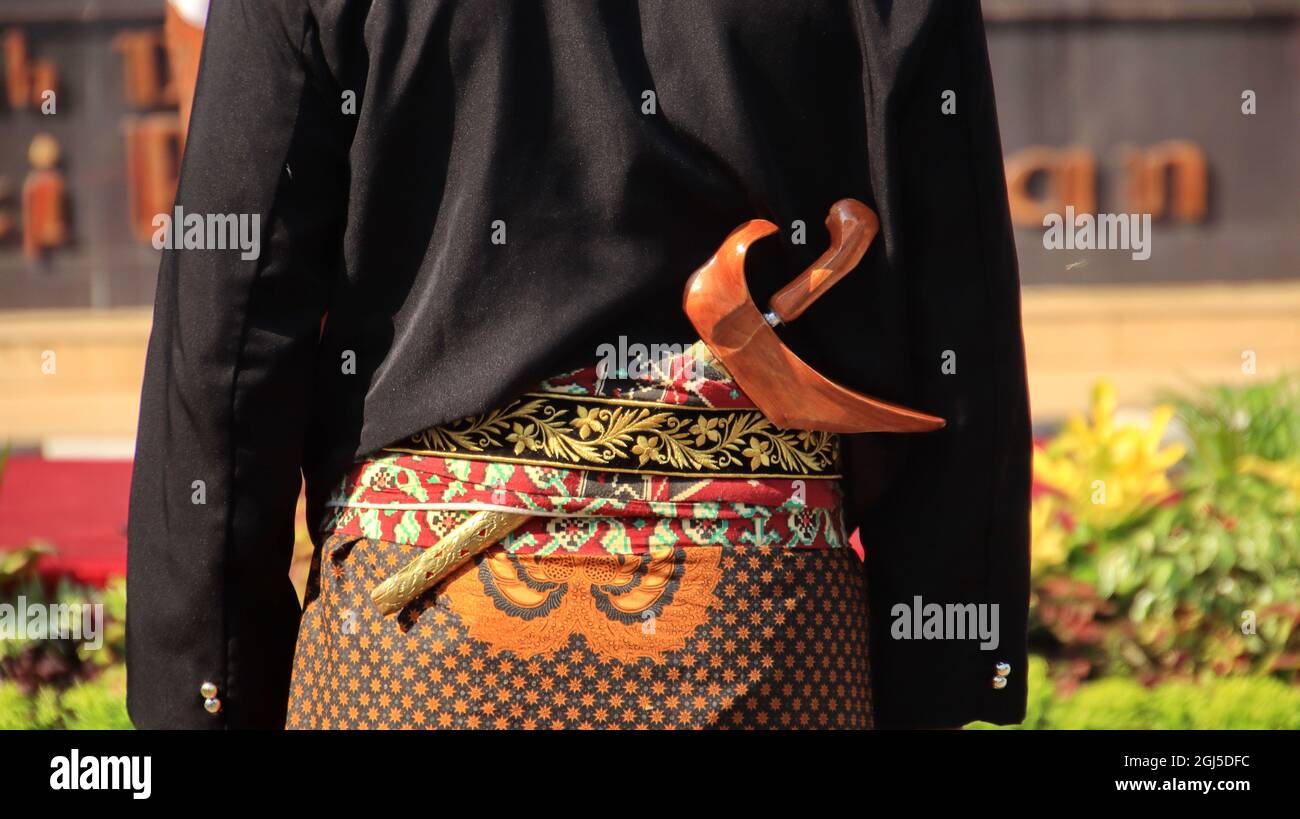 Men wearing traditional Javanese attire with keris Stock Photo - Alamy