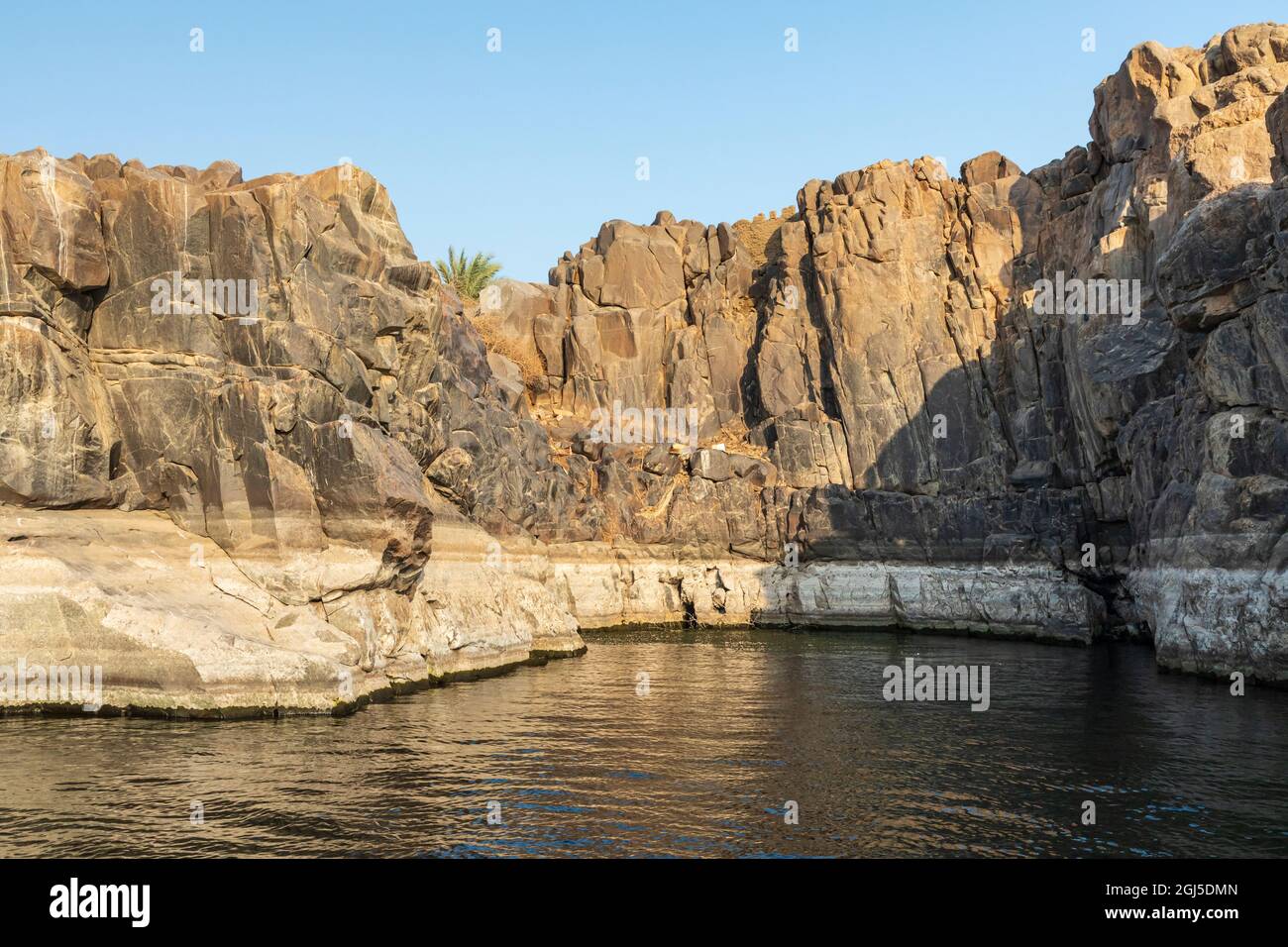 Africa, Egypt, Aswan. Rock cliffs along the banks of the Nile river in ...