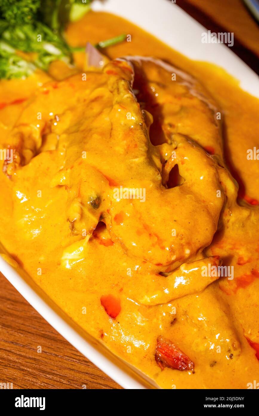 A plate of delicious Thai yellow curry braised prawns Stock Photo - Alamy