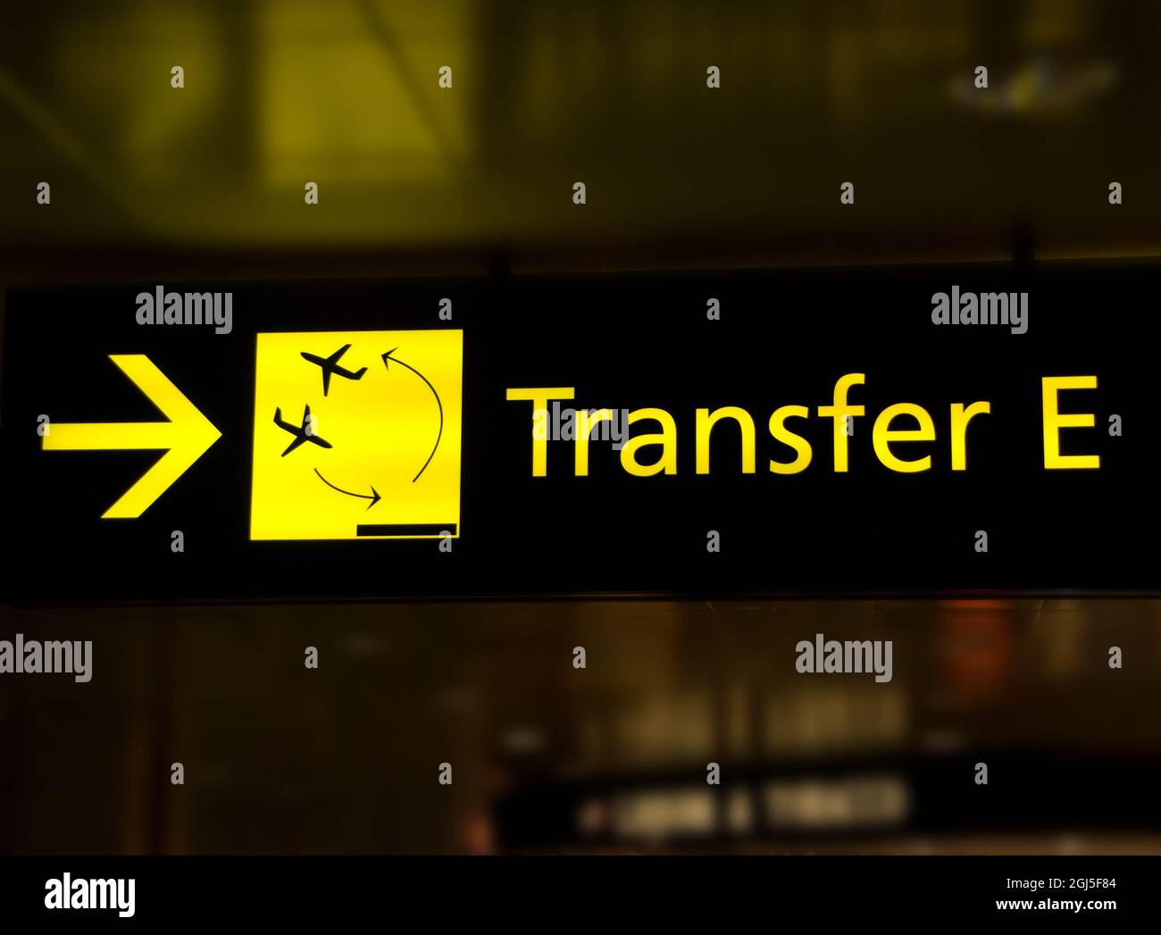 Yellow and black transfer sign on airport Stock Photo - Alamy