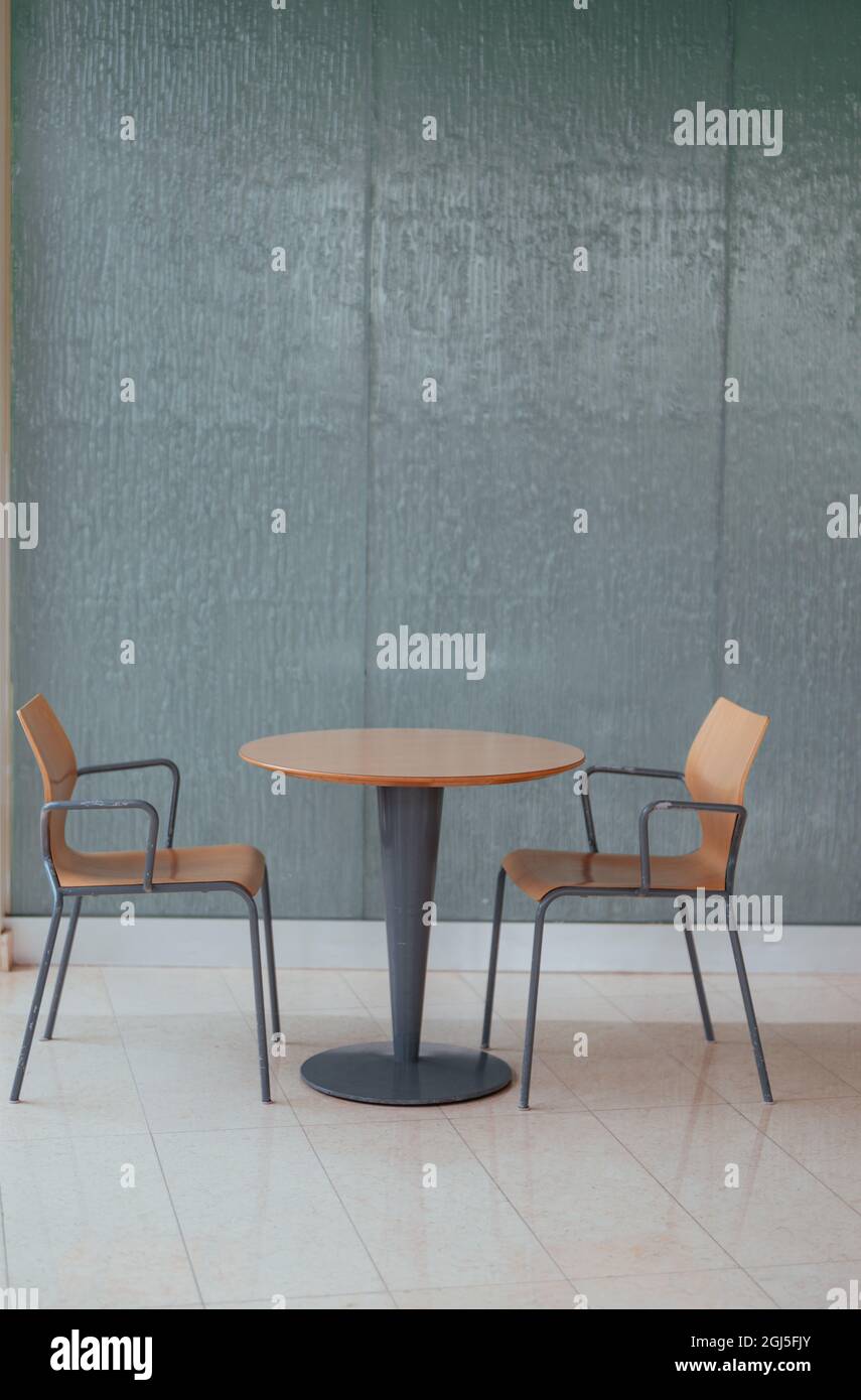 Modern simple round table with two chairs Stock Photo - Alamy