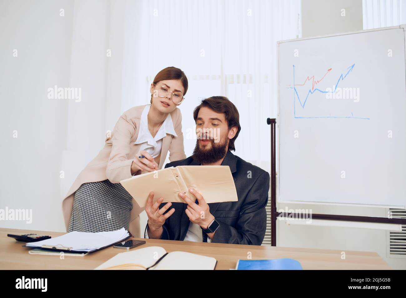 colleagues at work In the office at the desk communication discussion ...