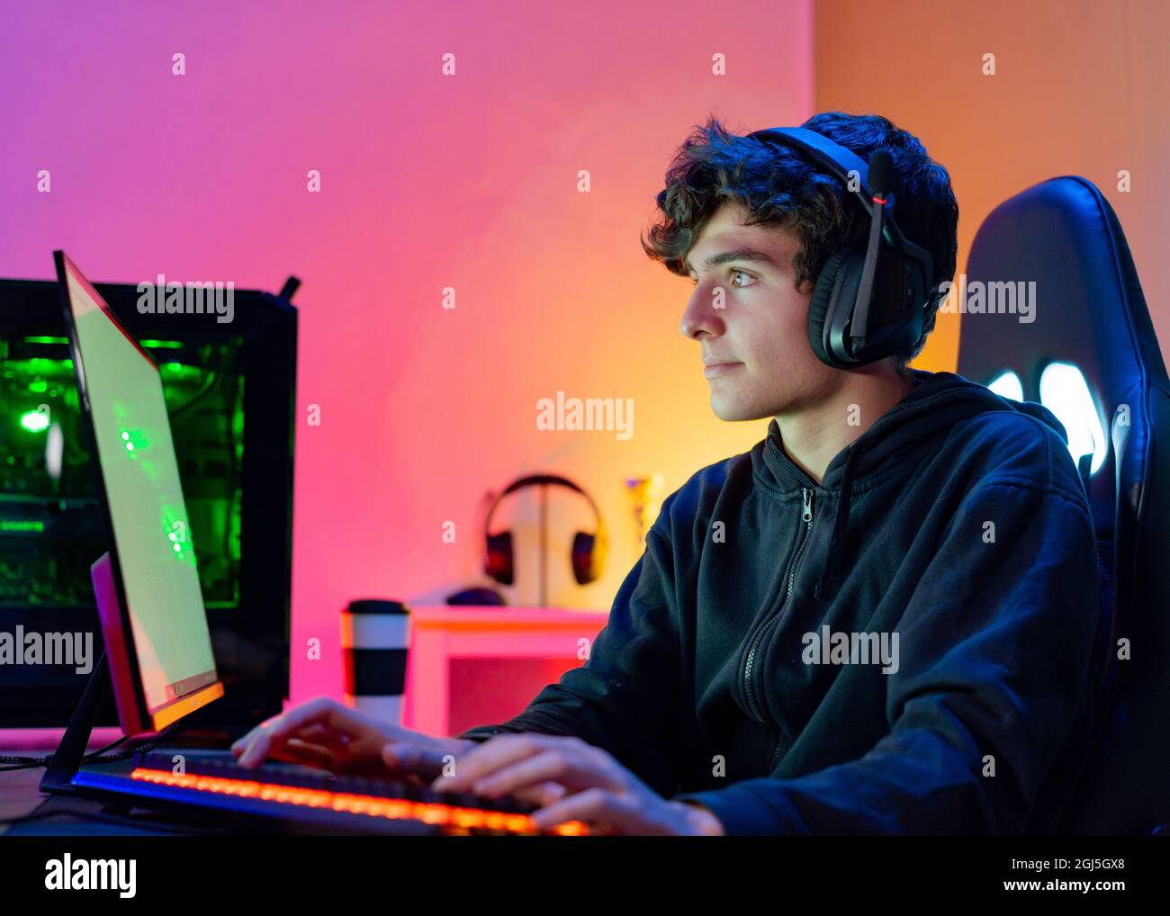 Teenager playing video game on computer Stock Photo - Alamy