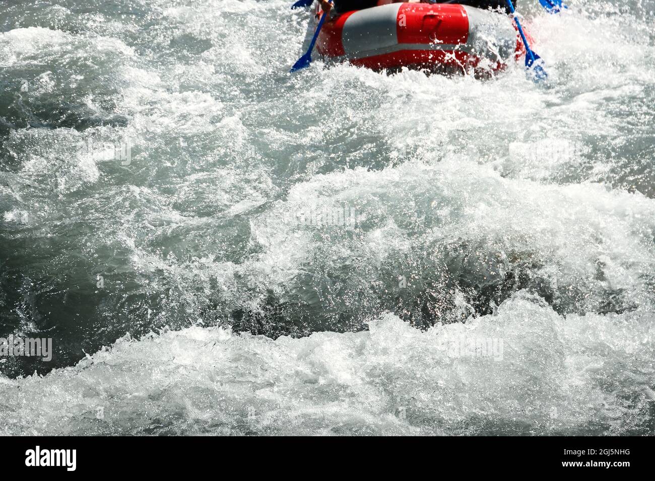 Rapid rapids of a mountain river with rafting tourists in an inflatable ...