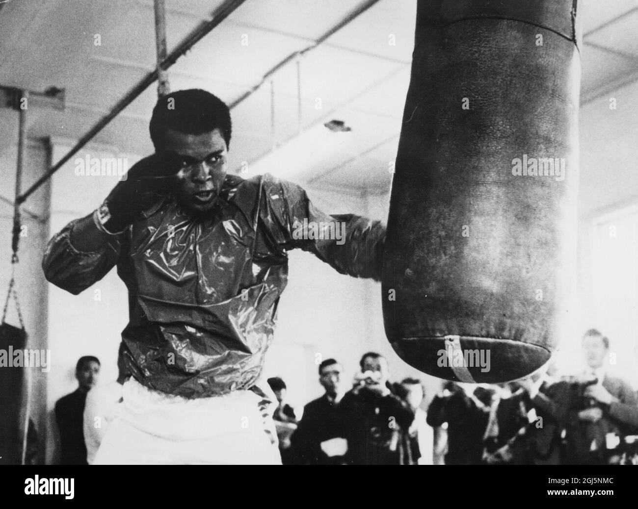 (Muhammad Ali) Cassius Clay American boxer training at punch bag Stock ...