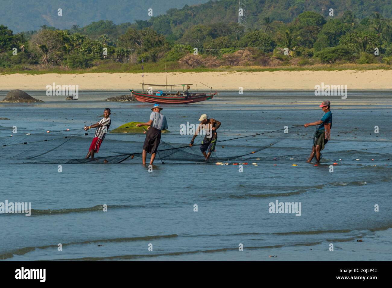 Fisherman pulling the fishing net out of the sea Stock Photo - Alamy