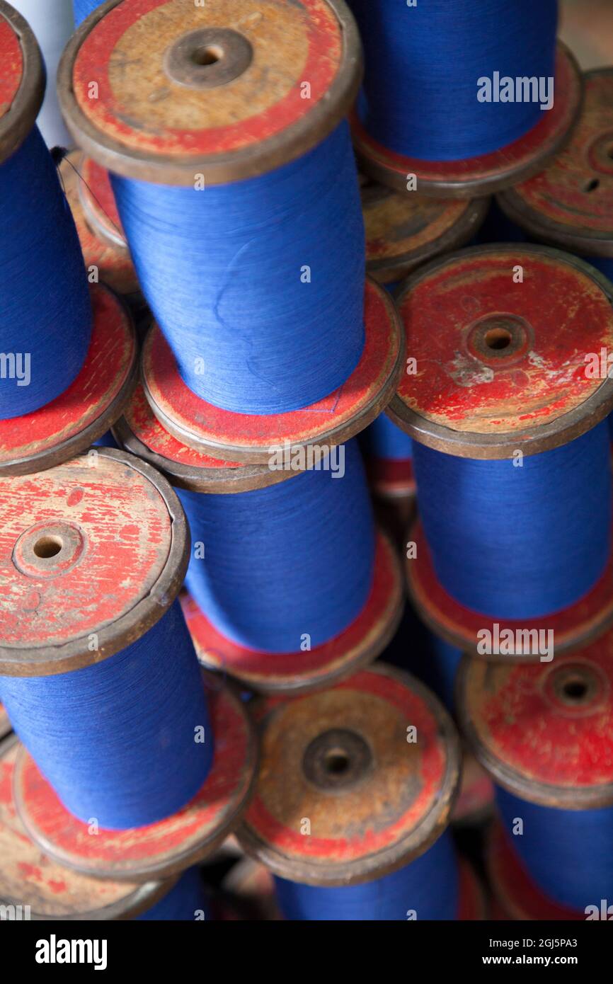 Making cotton threads on spools in fabric factory in Mandalay, Myanmar ...