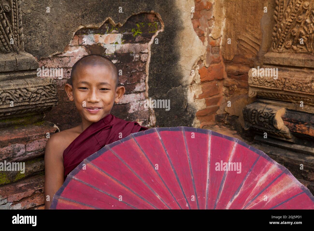 Young monk boy in traditional robes at a temple in Bagan, Myanmar Stock ...