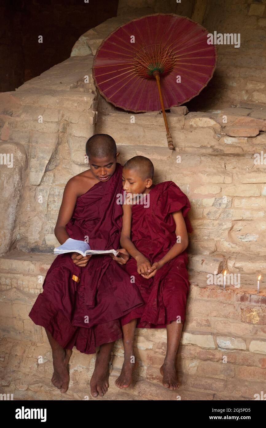 Young monk boy teaching in traditional robes at a temple in Bagan ...