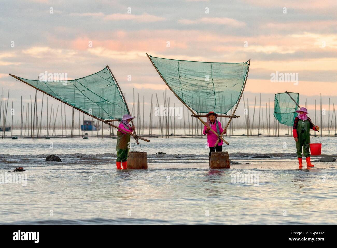 China, Fujian Province, Xiapu, Xiaohao. Three women pose with their ...