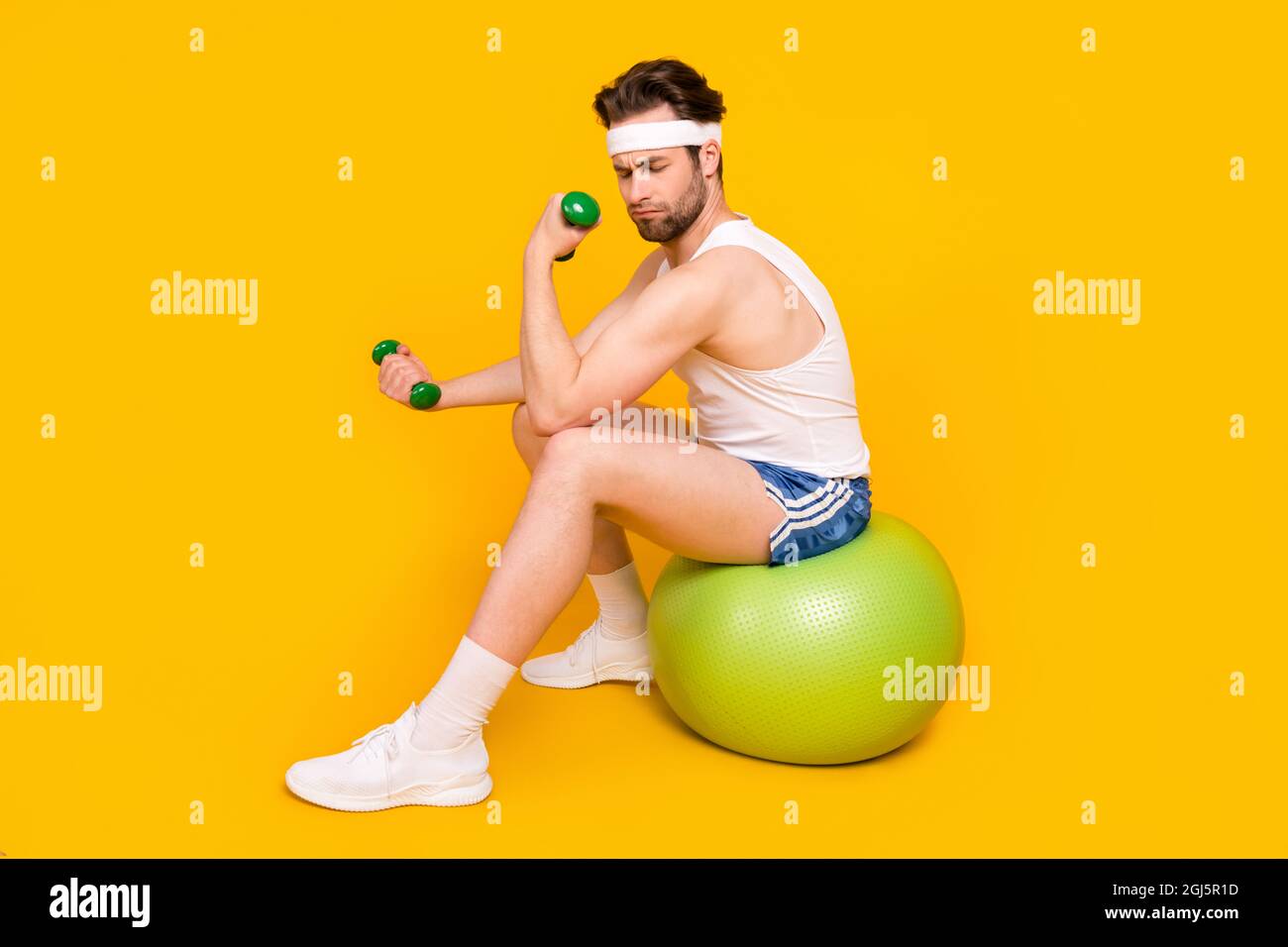 Full length body size profile side view of muscular strong guy sitting ...