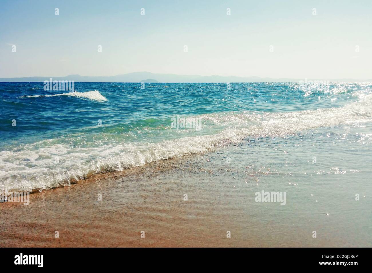 Wave of blue ocean on sandy beach Summer Background Stock Photo - Alamy