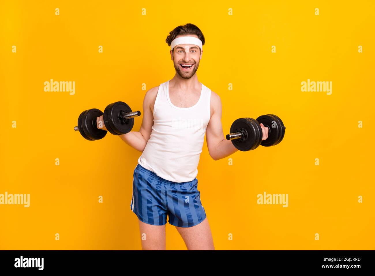Portrait of attractive cheerful sportive guy lifting weight doing ...