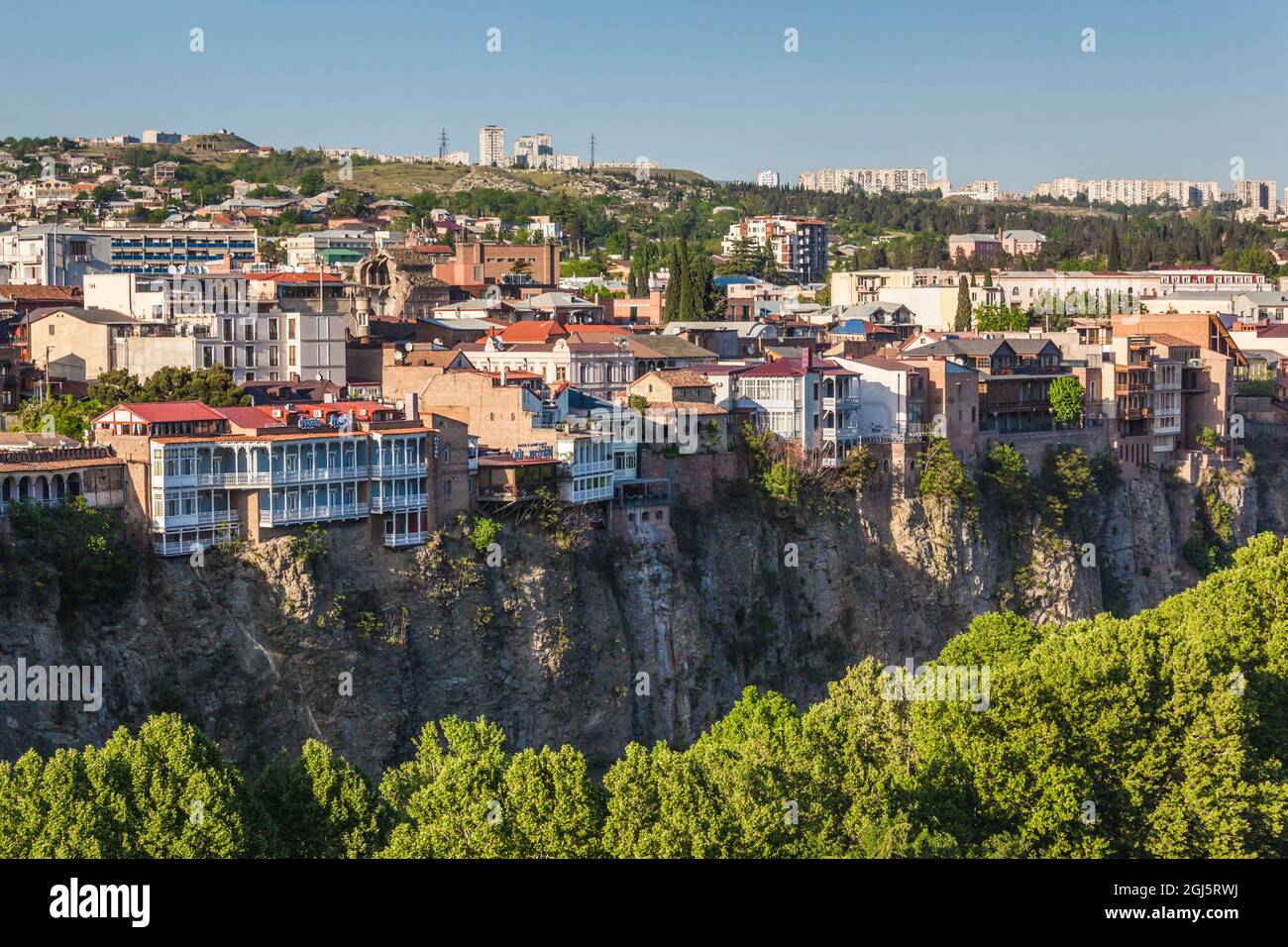 Georgia, Tbilisi. Avlabari, cliffside buildings above Mtkvari River ...