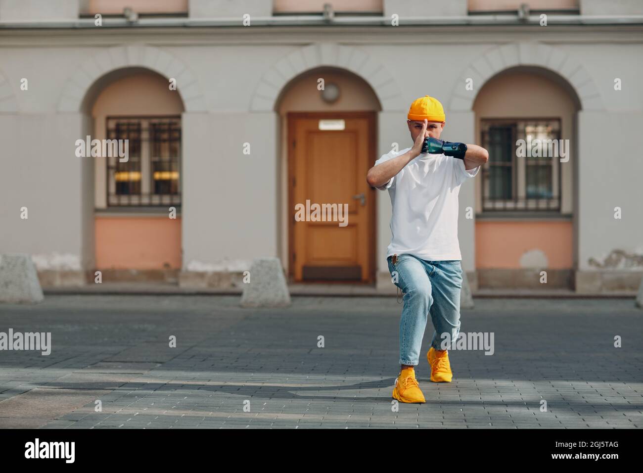 Young disabled karate man with artificial prosthetic hand in casual ...