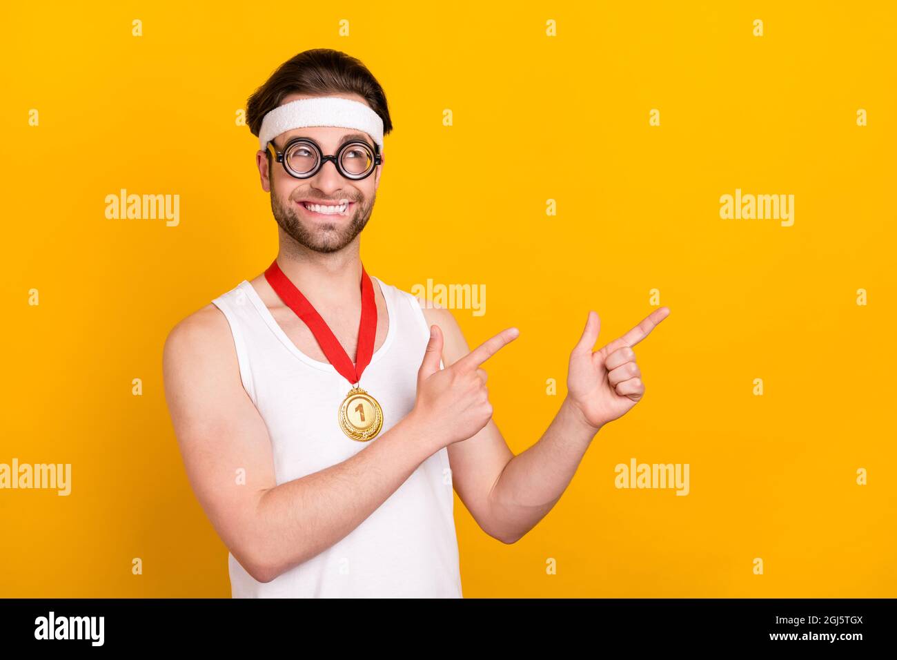 Portrait of handsome cheerful guy nerd demonstrating copy space ad look ...