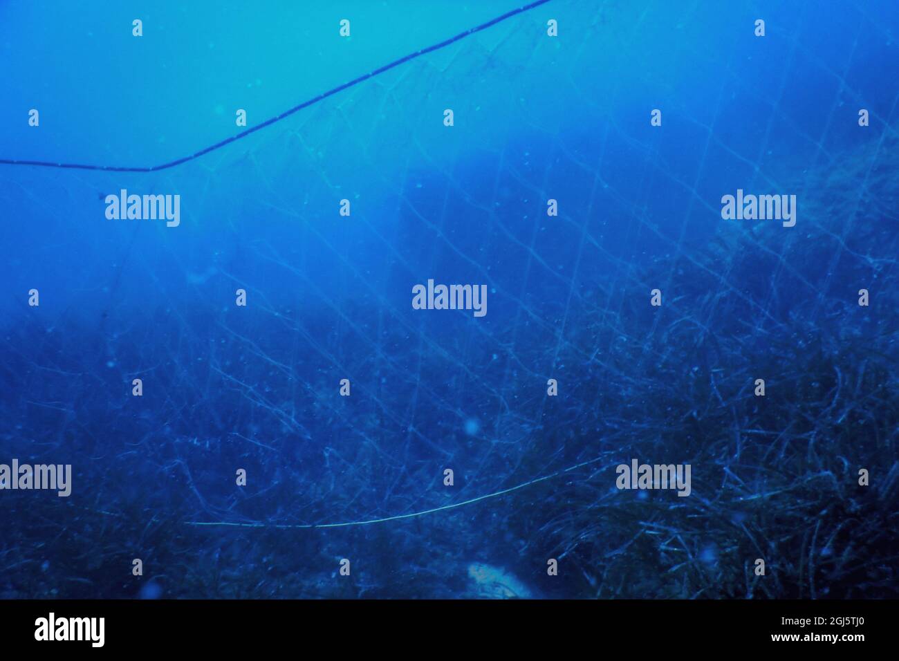 A fishing net underwater fixed on the seabed, deep water Stock Photo ...