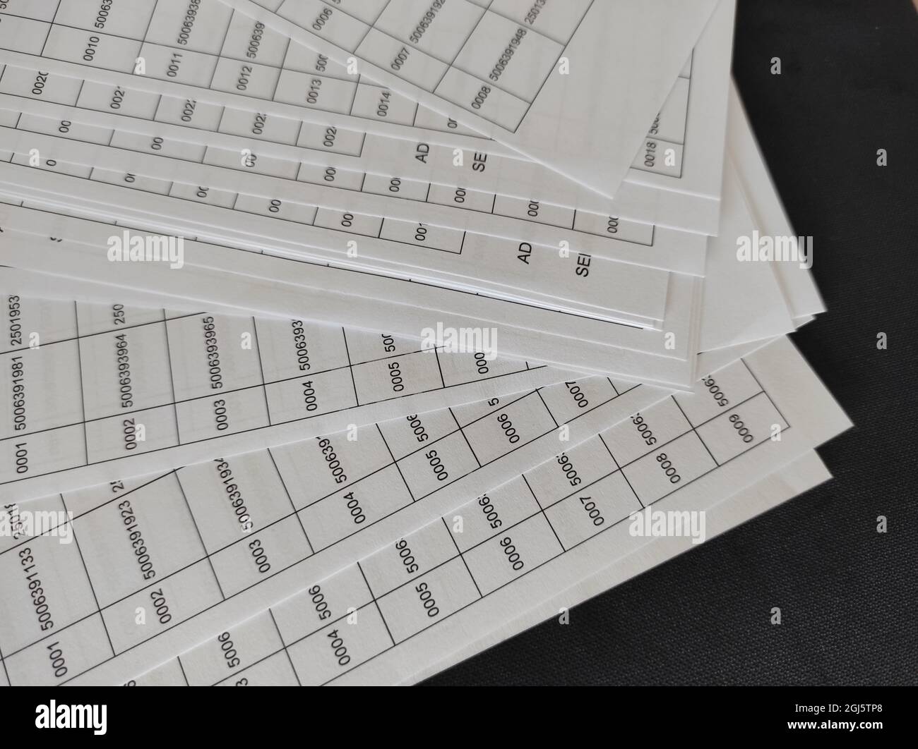 Pile of papers with many numbers printed on them Stock Photo - Alamy