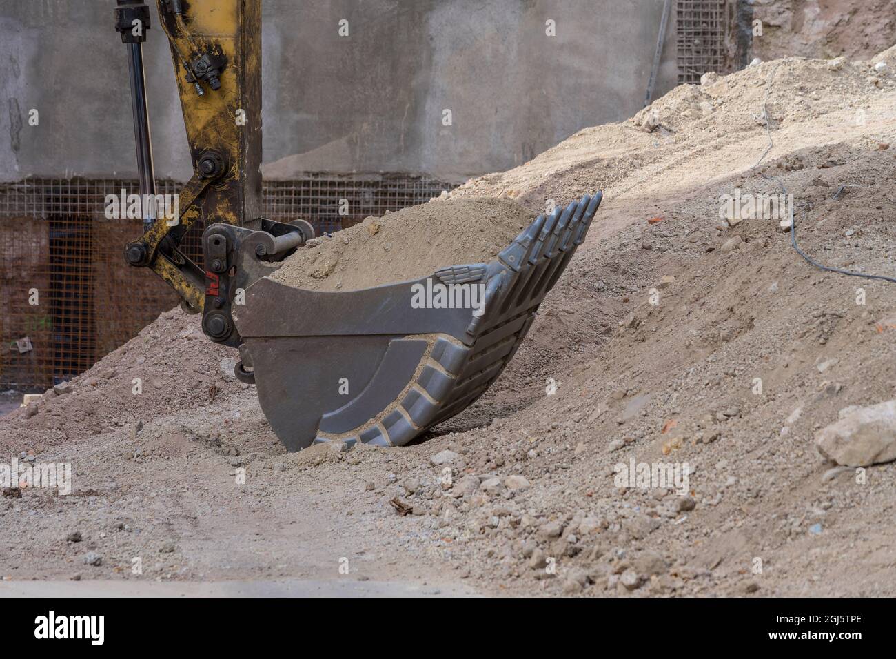 Skid steer bucket of the tractor on the sand Stock Photo - Alamy