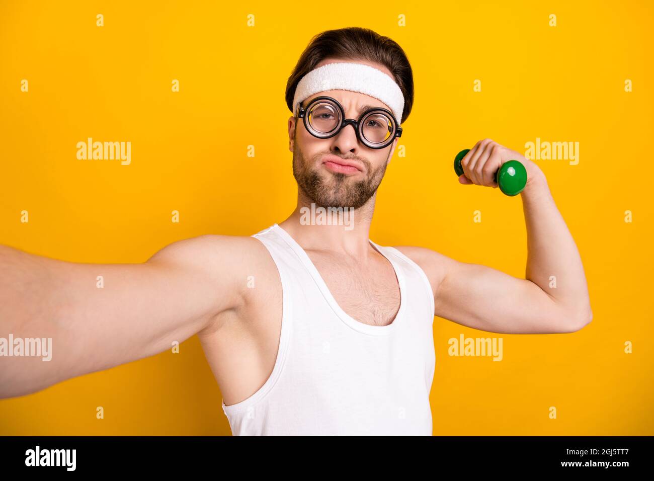 Self-portrait of attractive funky guy nerd doing work out body building ...