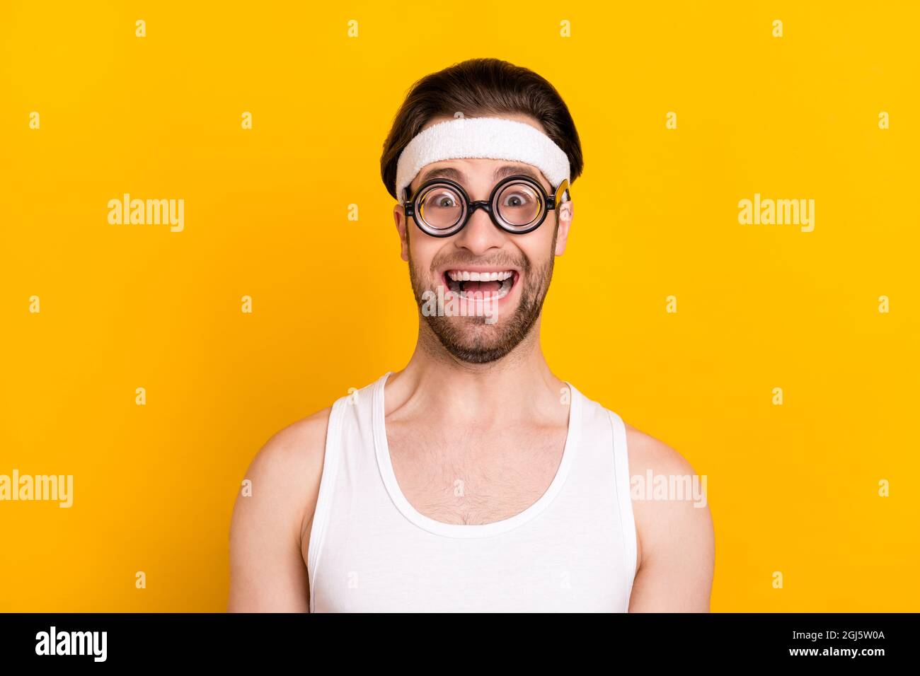 Portrait of attractive cheerful guy sportsman nerd having fun good mood ...