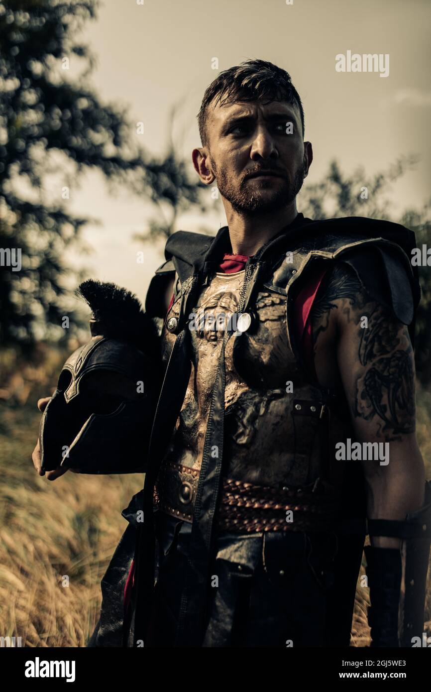 Portrait of ancient Spartan warrior in battle dress with helmet in his ...