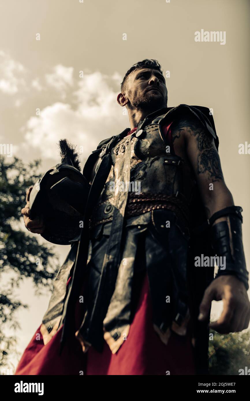 Portrait of ancient Spartan warrior in battle dress with helmet in his ...