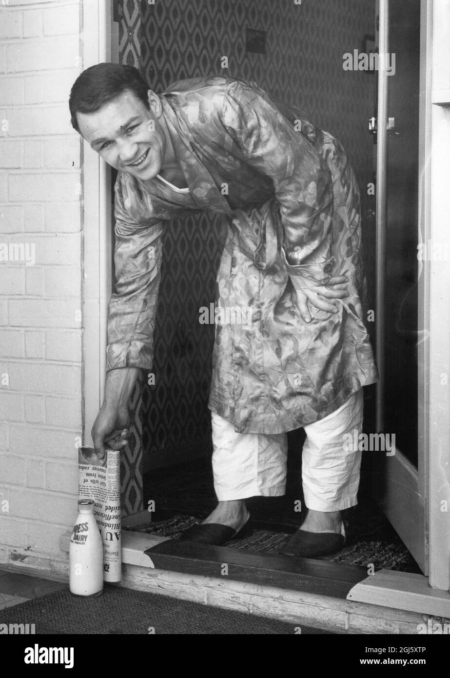 Dave Charnley , lightweight boxing Champion collecting newspaper and ...