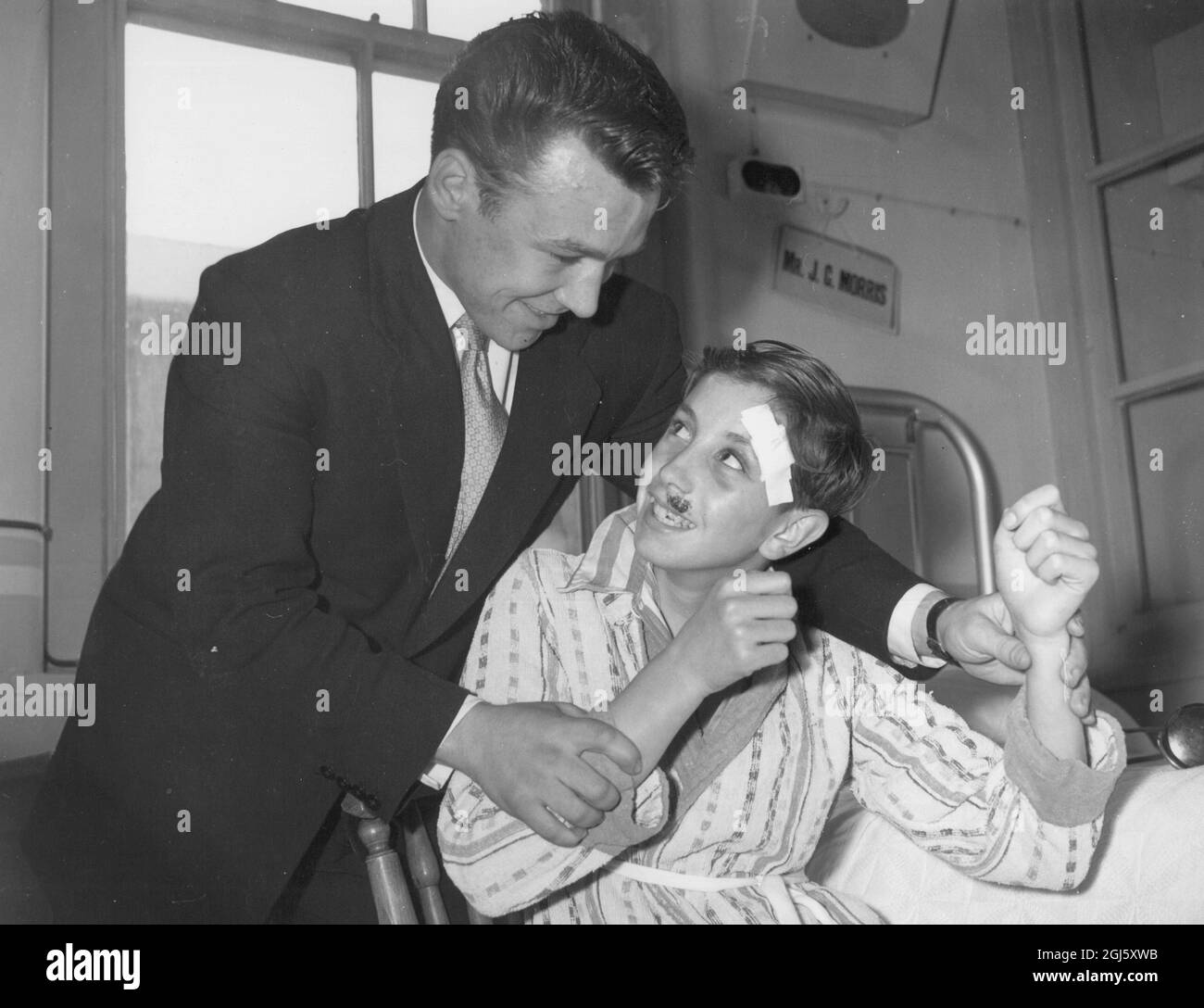 British boxer Dave Charnley with injured child Stock Photo - Alamy