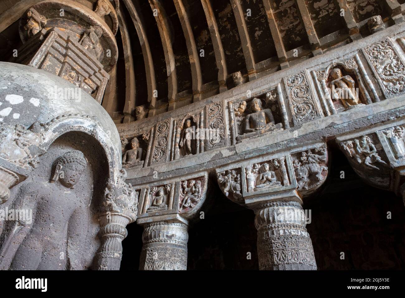 India, Ajanta, Ajanta Caves. Interior view of ornate carvings and stone ...