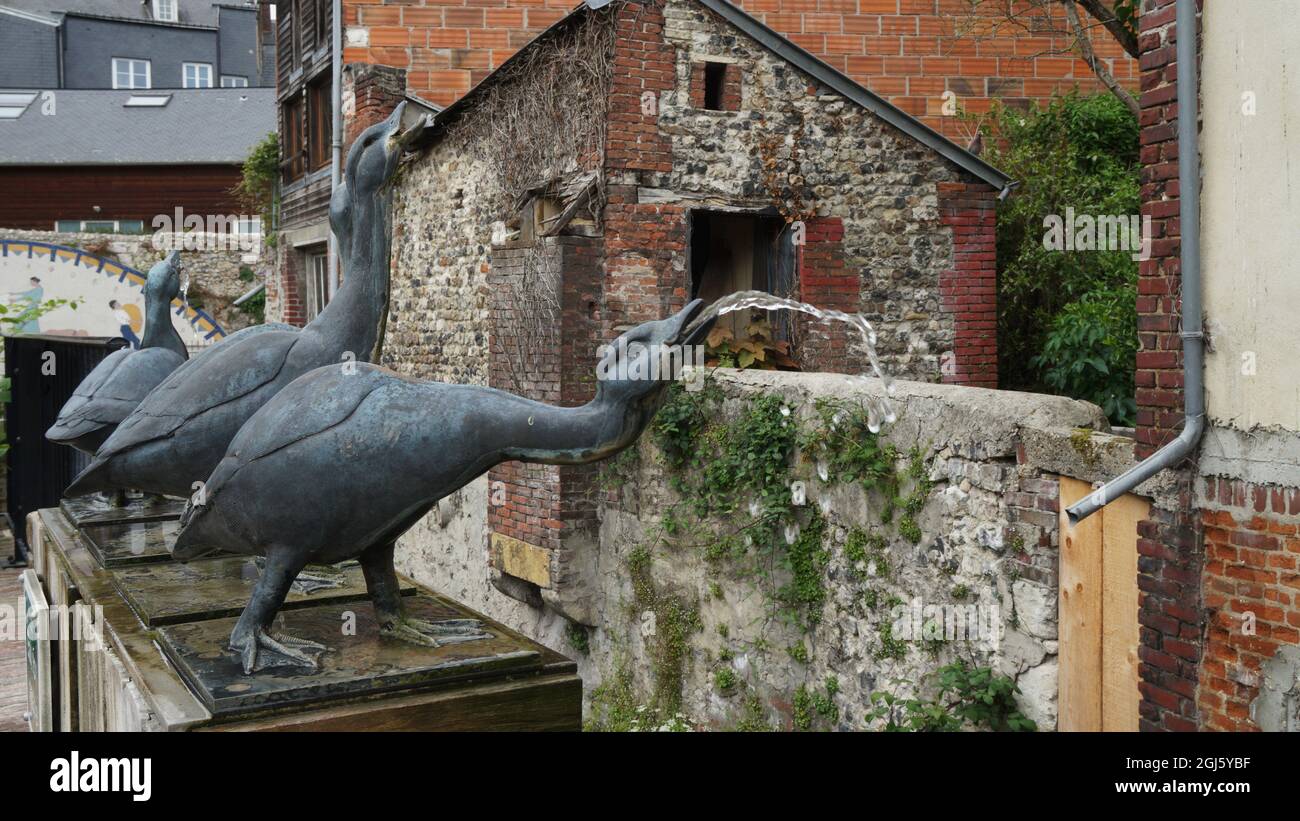 bronze geese with running water flowing from their mouths, in front of ...