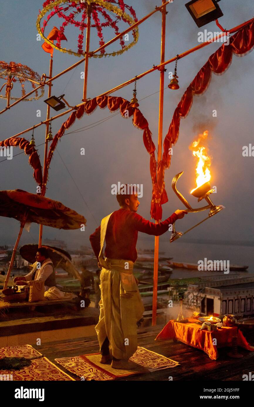 India, Uttar Pradesh, Varanasi, Ganges River. A priest performs a ...