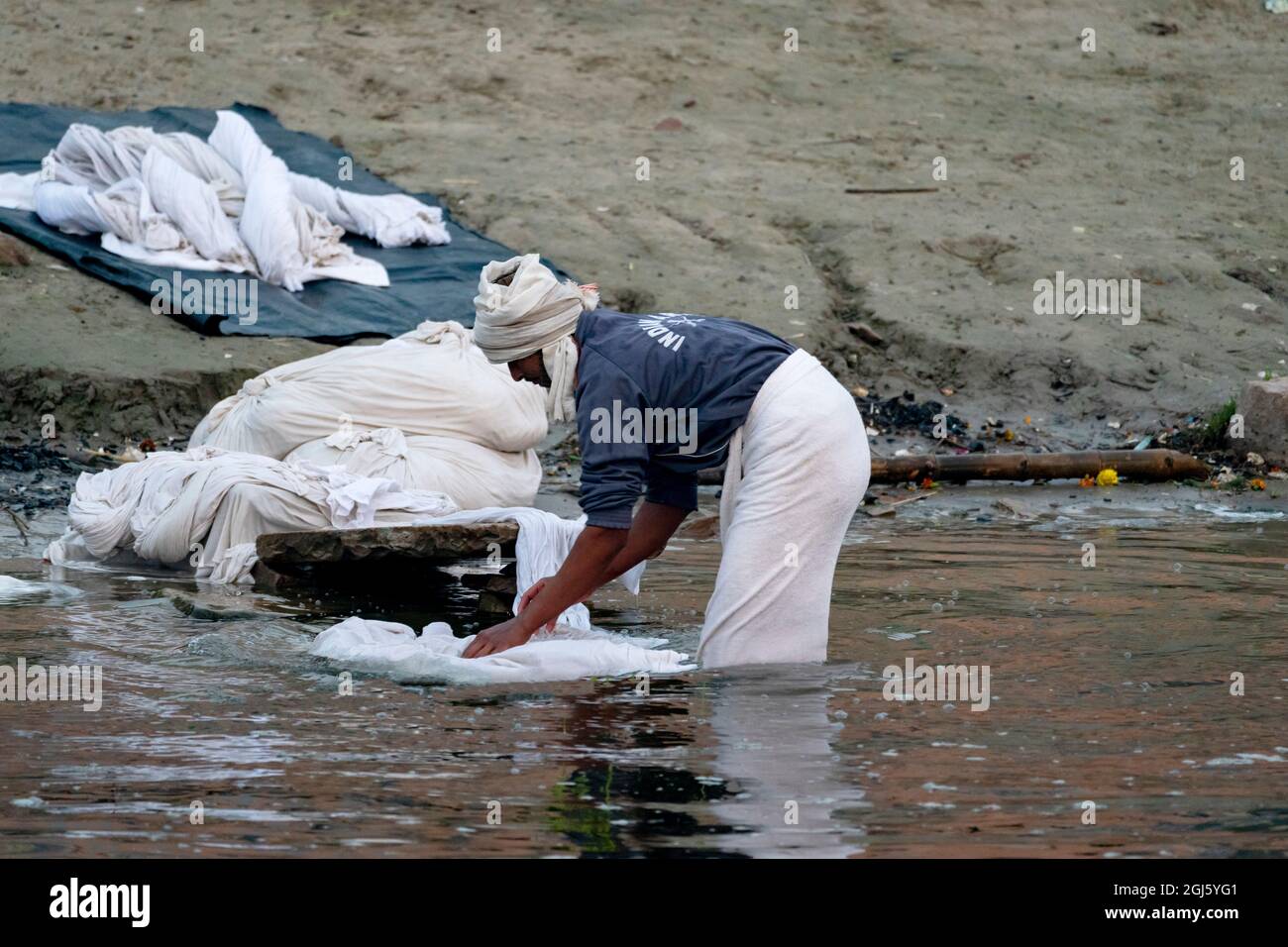 India, Uttar Pradesh, Varanasi, Ganges River. A man does the hotel ...