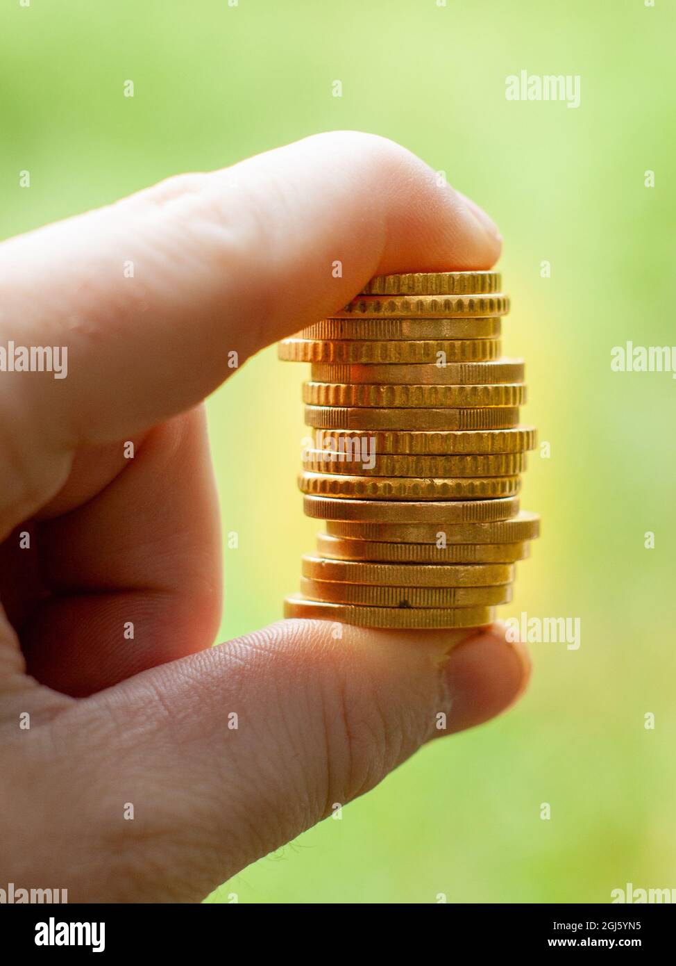 Hand holding coin stack hi-res stock photography and images - Alamy