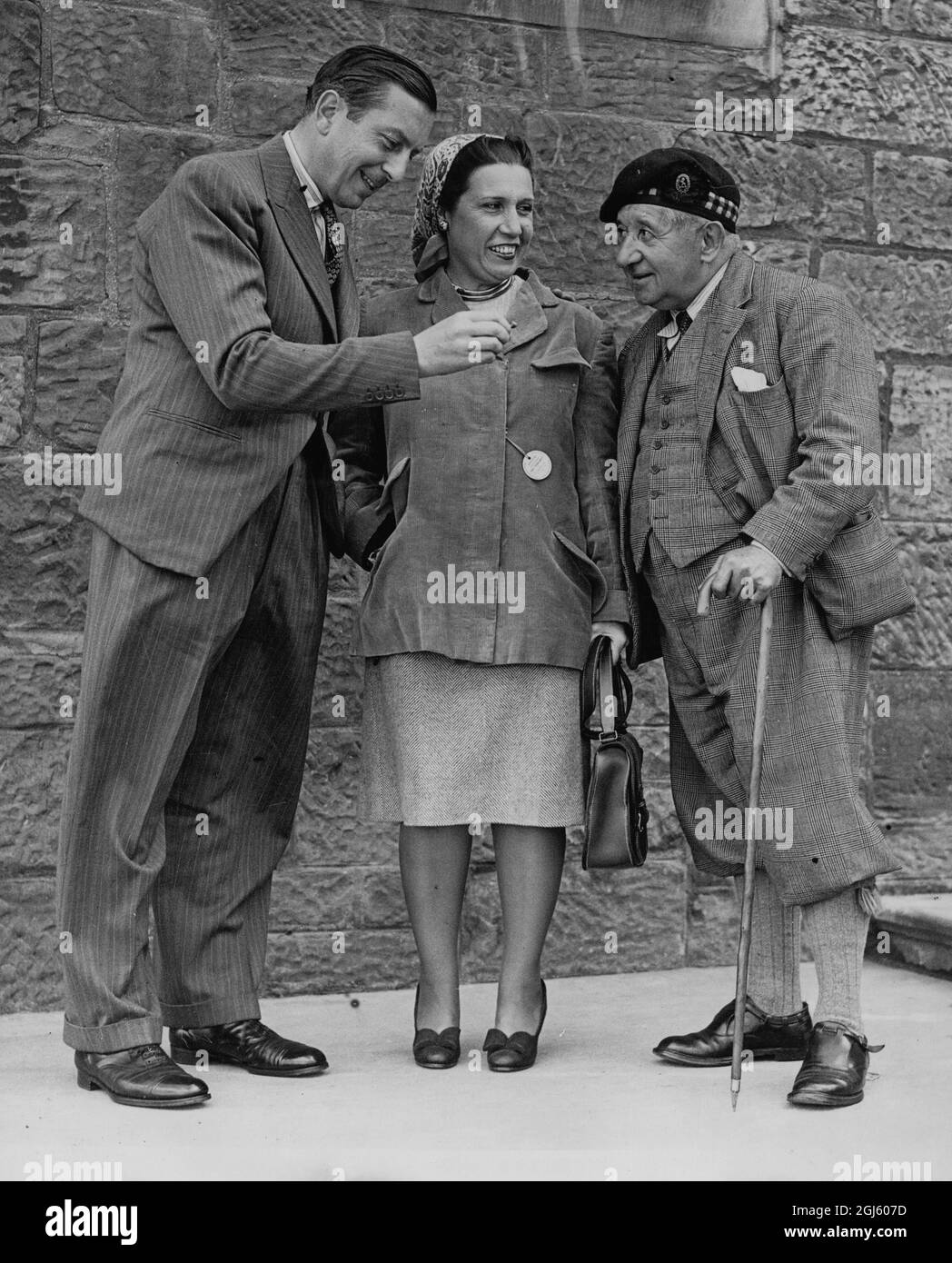Henry Cotton English Golfer shows his favourite tee to his wife and ...