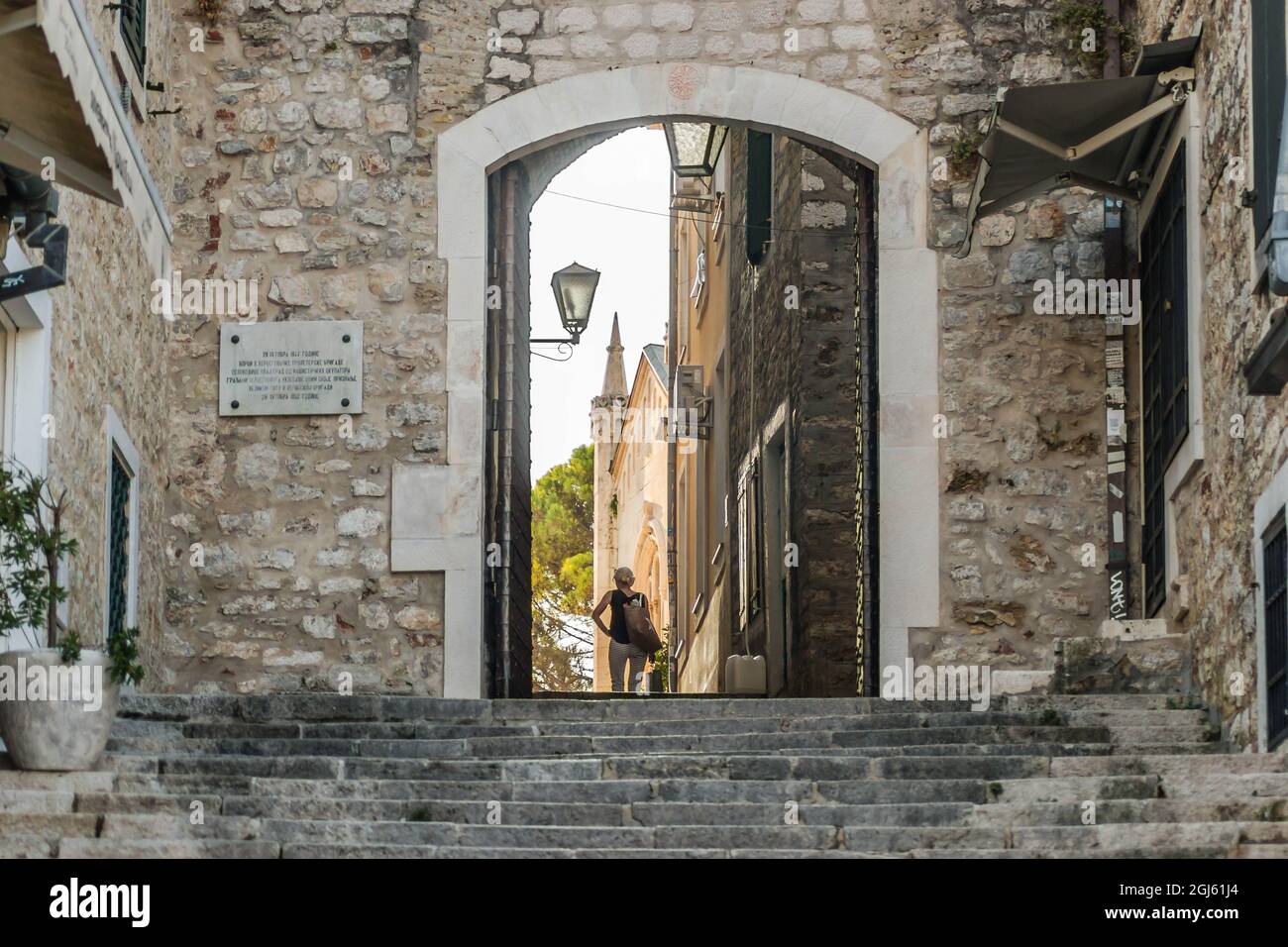 Old town gate with the small clocktower surrounded by old houses Stock ...