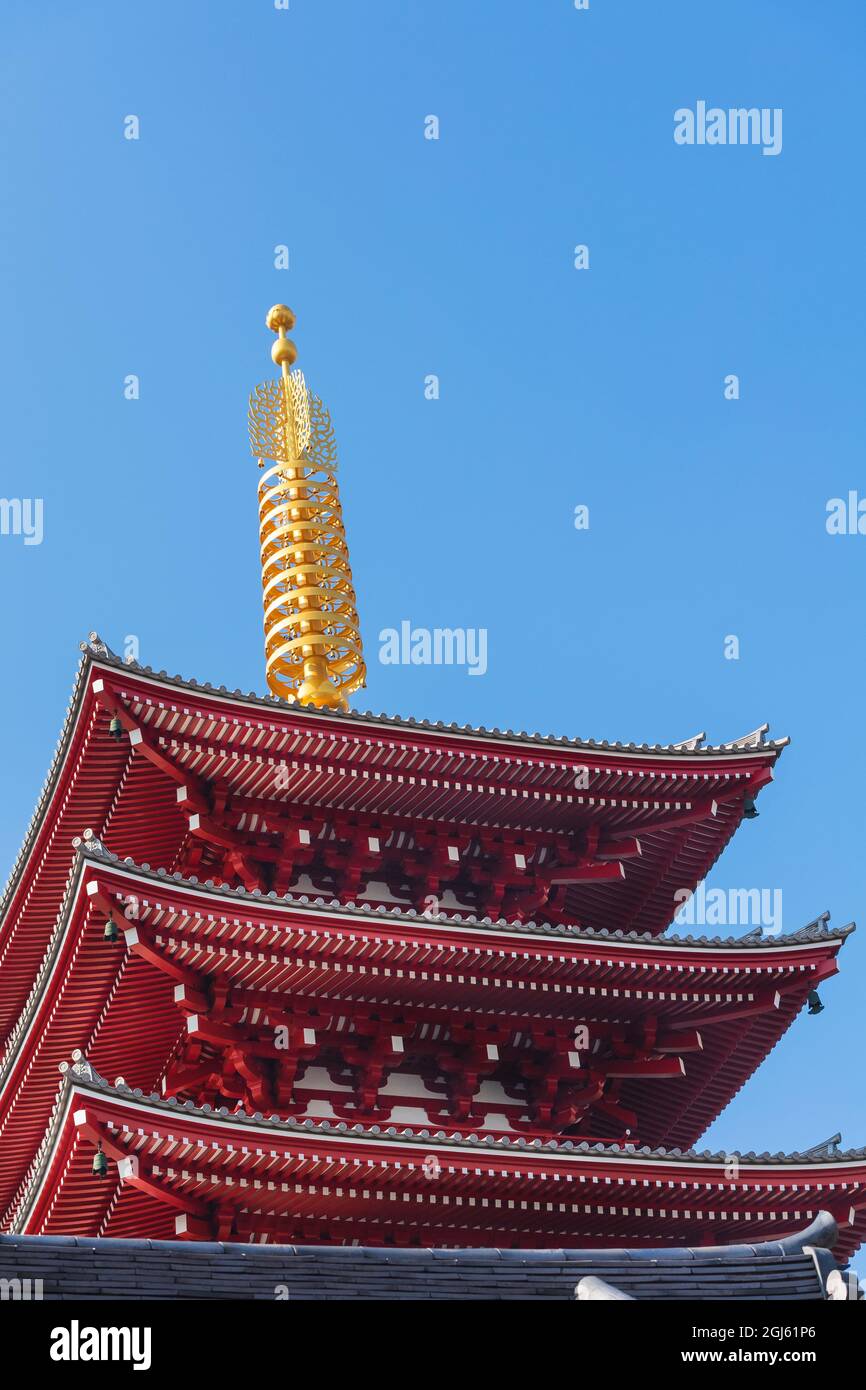 The red 3 tiered roof of a Japanese temple against the blue sky Stock ...