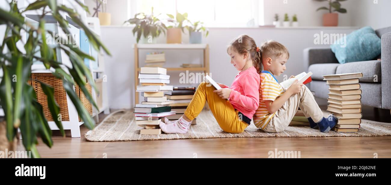 Boy sitting on floor reading book hi-res stock photography and images ...