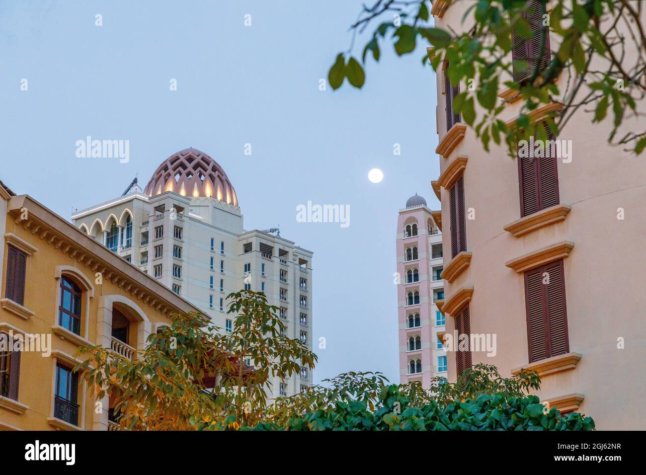 State of Qatar, Doha. Full moon seen through tall buildings near Pearl ...
