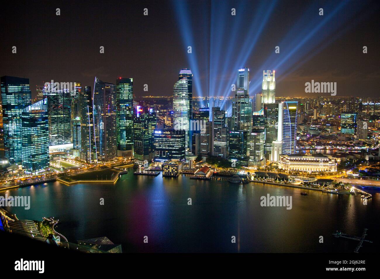Singapore. Searchlights and city building at night Stock Photo - Alamy