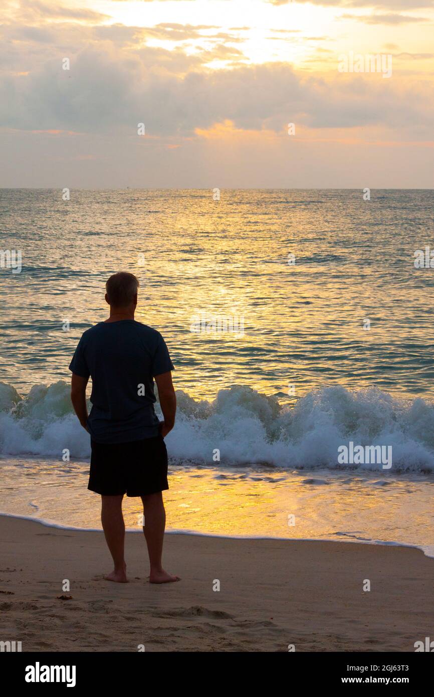 Thailand, Ko Samui. Man in silhouette watching light surf hitting the ...