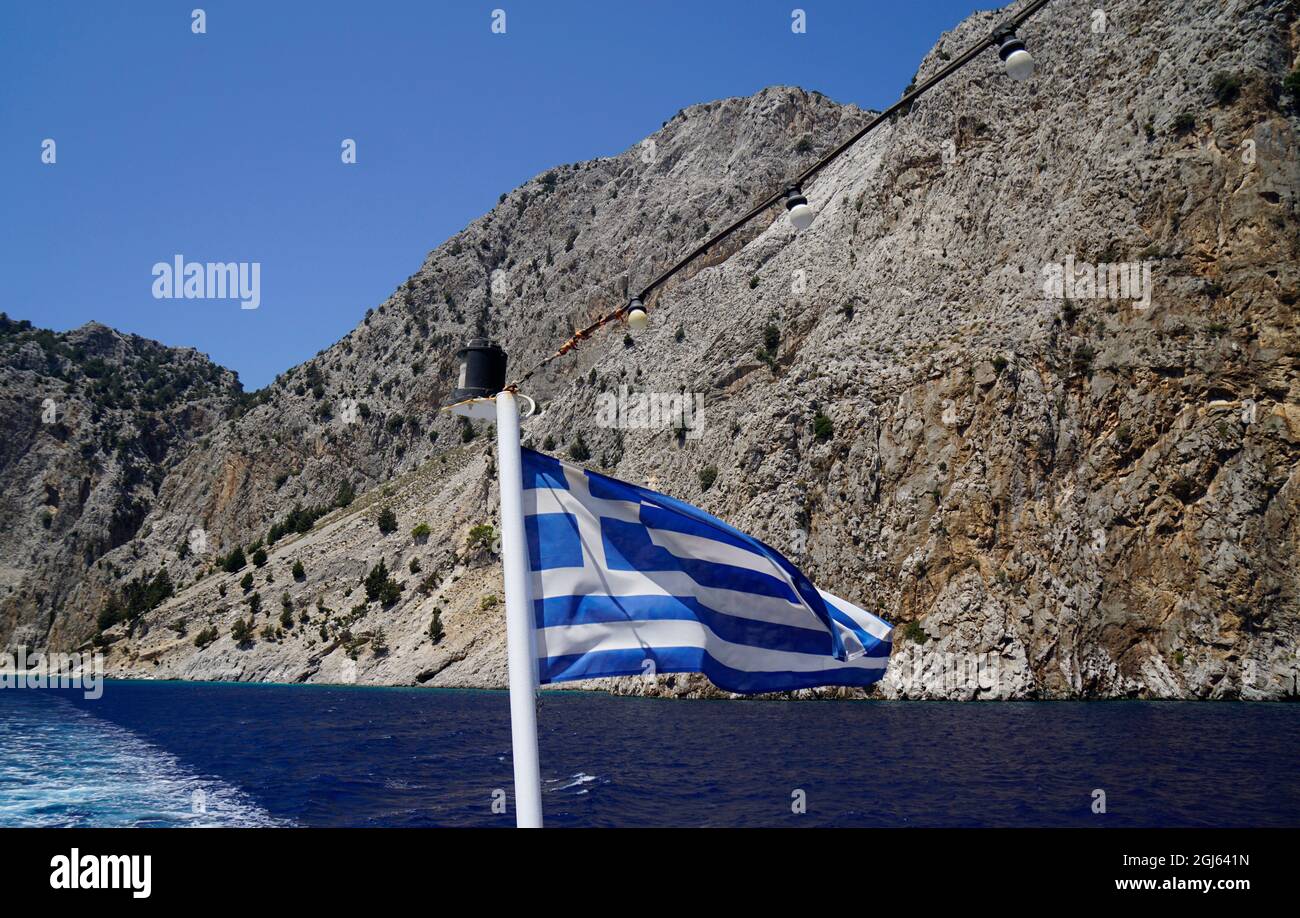 greek flag in the wind on an island Stock Photo - Alamy